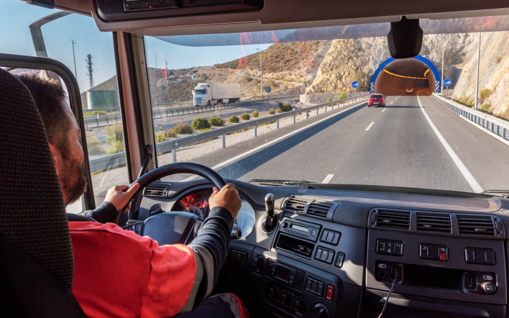 Person Driving Car Hauler on Freeway - JMN Logistics & Transportation